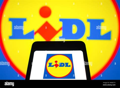 In This Photo Illustration The Lidl Logo Is Displayed On A Smartphone Screen And In The
