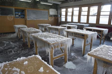 Frozen Classroom With Icicles Hanging From Desks And Chalkboard