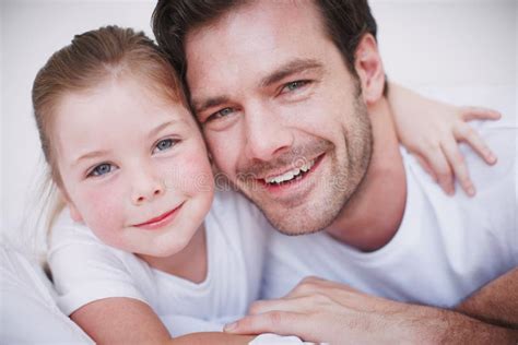 Devoted Dad Portrait Of A Father And Daughter Lying Next To Each Other