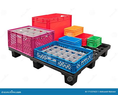 Plastic Multi Colored Crates And Boxes At Transport Pallet Isolated On