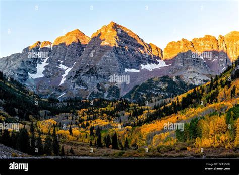 Maroon Bells Dark Peak At Lake With Sunrise Sunlight In Aspen Colorado