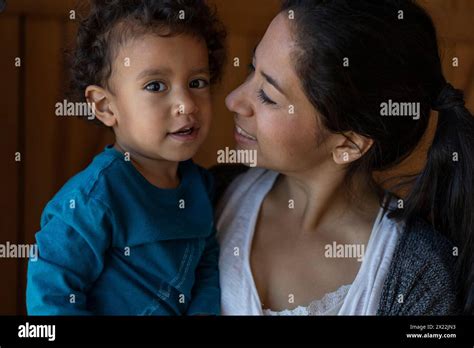 Latin American Mom And Son Is Lifted In Arms Both Look Happy Mother S Day Concept