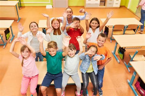 Happy School Students Waving In Classroom Stock Image Image Of