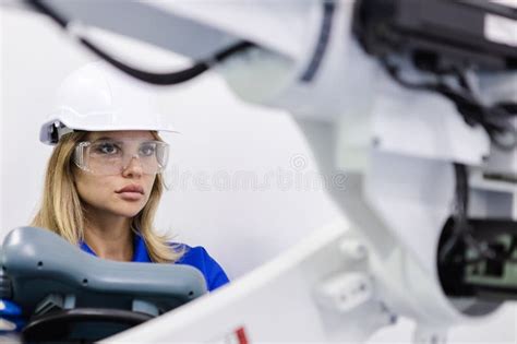 Female Technician Engineer Using Remote Control Automation Robotics At Industrial Modern Factory