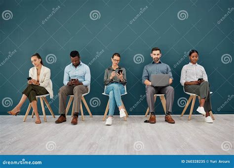 recruitment phone and laptop chair row of people at workspace corridor