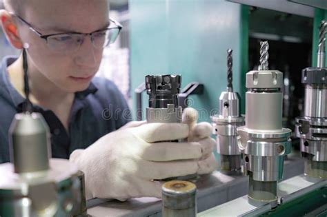 A Working Machine Operator Inspects A Cutter For A Cnc Machine From A