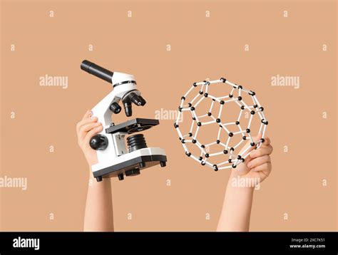 Female Hands Holding Molecular Model With Microscope On Beige Background Chemistry Lesson