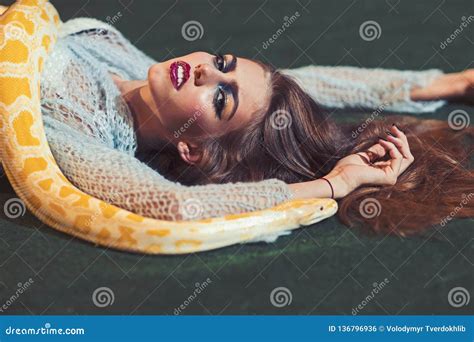 Beauty Model With Makeup Face And Yellow Serpent Sensual Woman Relax With Albino Python Stock