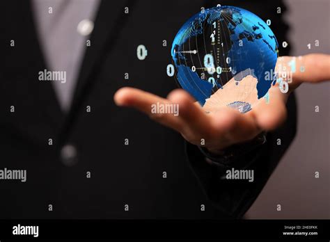Businessman Holding A Render Of A Globe With Binary Code Global