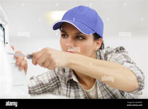 Woman Using Screwdriver On An Electrical Appliance Stock Photo Alamy