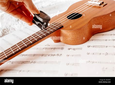 Tuning Your Guitar With A Tuner At Home High Quality Beautiful Photo Of A Musical Wooden