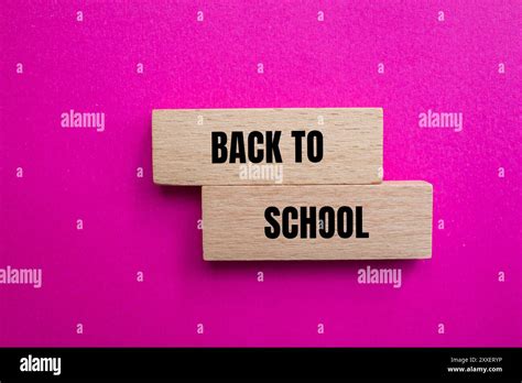 Back To School Message Written On Wodoen Blocks With Pink Background