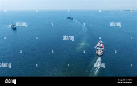 Stern Of Large Cargo Ship Import Export Container Box On The Ocean Sea On Blue Sky Back Ground