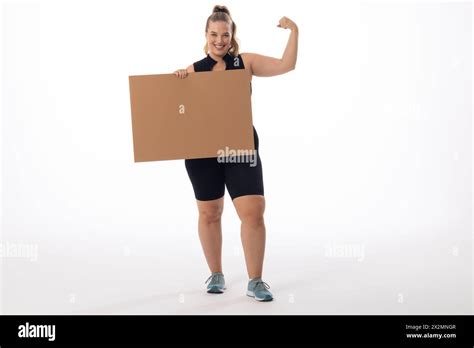 A Caucasian Plus Size Model With White Background Holds A Sign Copy