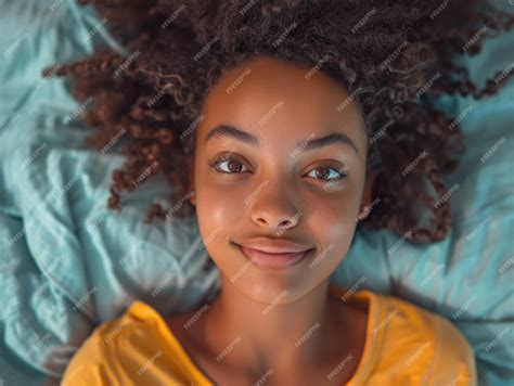 Premium Photo A Curly Haired Girl Lying In Bed Looking At The Camera