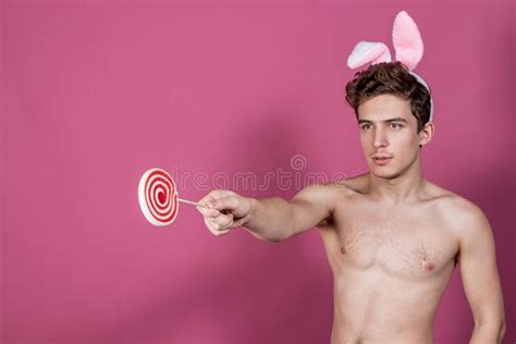 Funny Naked Guy Wearing Bunny Ears Holding Lollipop Over Pink Background Stock Image Image Of