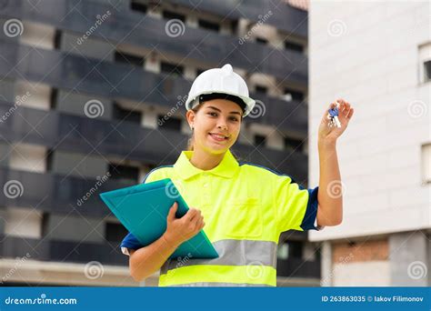 Portrait Of A Young Smiling Woman Working As A Process Engineer Demonstrating The Keys Stock