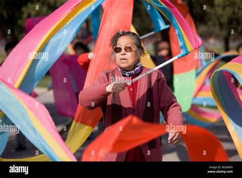 Woman Practises Tai Chi Dancing With Ribbons In Park Of The Temple Of