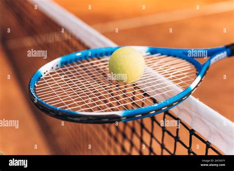 Tennis Racket With A Ball On The Tennis Net Stock Photo Alamy