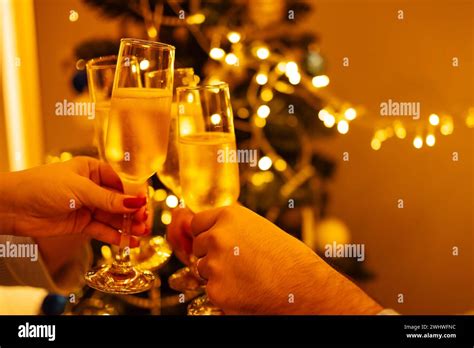 Female And Male Hands Holding Glasses With Champagne And Clicking Them People Make Festive