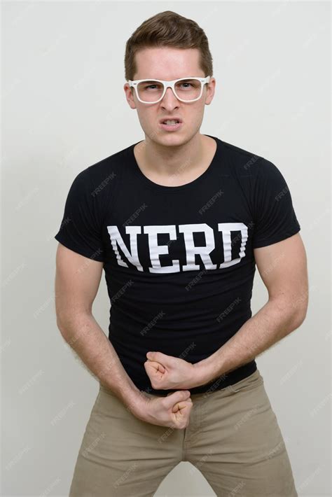 Premium Photo Portrait Of Young Handsome Nerd Man Against White Wall