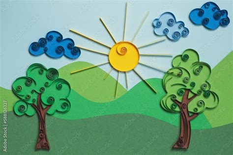 The Sun With Clouds With Trees Isolated On A Green And Blue Paper Background Two Trees On The