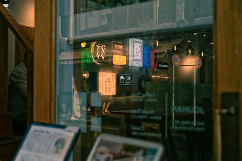 Storefront Window With Reflections And Illuminated Signs Photo Free
