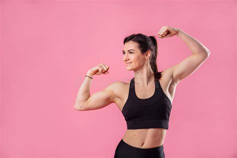 Half Lenght Portrait Of Beautiful Pumped Up Girl In A Black Tight Fitting Top And Leggings