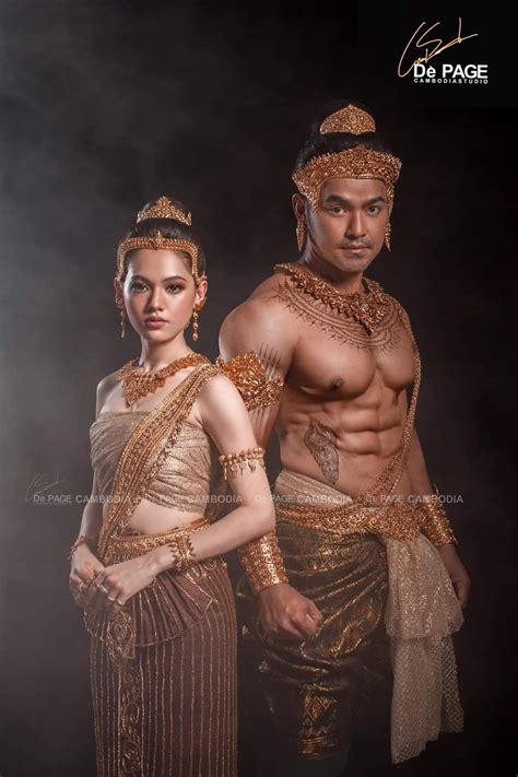 Two People Dressed In Costumes Standing Next To Each Other On A Black And Blue Background