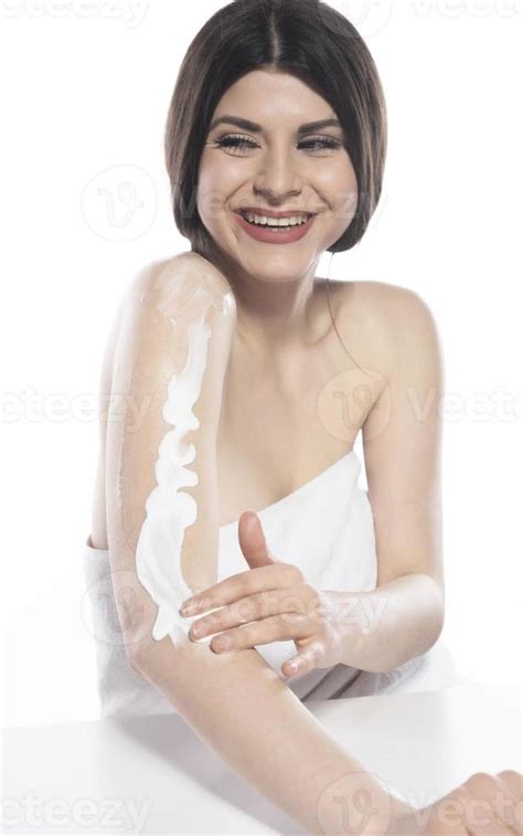 Beautiful Skinned Woman Applying Body Lotion On White Background