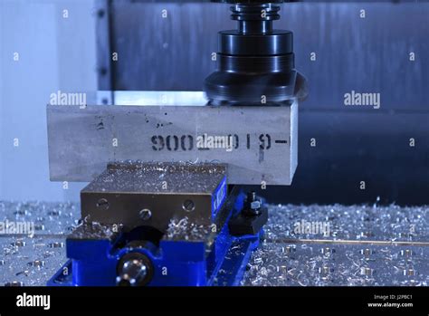 a computer numeric controlled milling machine molds a block of aluminum into an aircraft