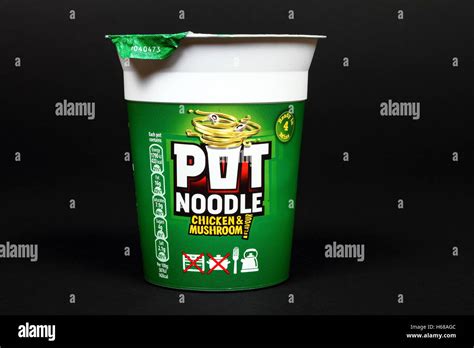 Golden Wonder Chicken And Mushroom Pot Noodle Isolated On A Black