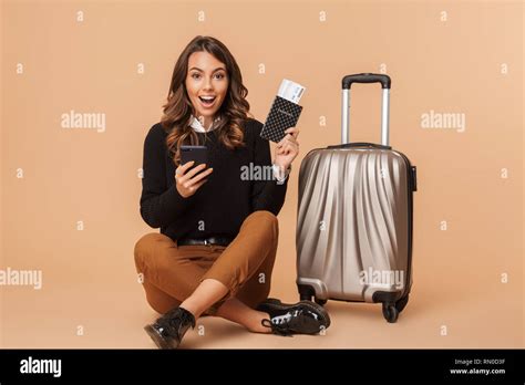 Elegant Woman With Baggage Holding Smartphone And Travel Ticket While
