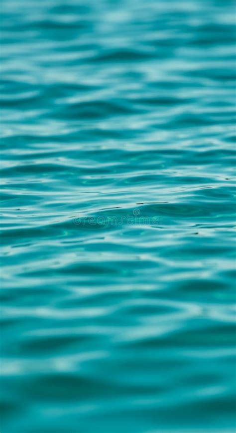 Gentle Turquoise Waves Ripple Across A Body Of Water Creating A Serene And Fluid Texture Stock