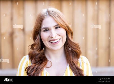 Beautiful Happy Redhead Woman Against Wooden Wall Stock Photo Alamy
