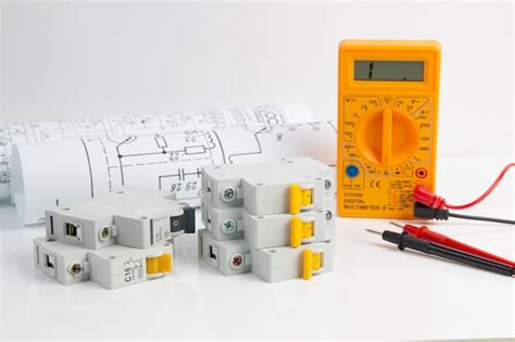 Premium Photo Digital Multimeter And Circuit Breaker With Paper