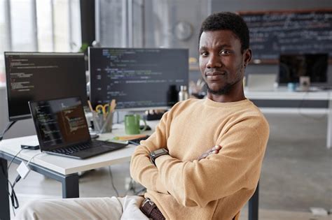 Premium Photo Portrait Of African American Programmer Looking At Camera While Sitting In It Office