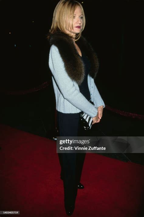 American Actress Ellen Barkin Wearing A Pale Blue Jacket With A Fur