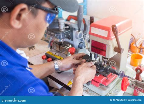 Locksmith In Workshop Makes New Key Professional Making Key In Locksmith Stock Image Image Of