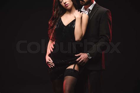 Attractive Sexy Couple In Black Dress And Tuxedo Hugging Isolated On