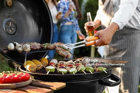 야외에서 바베큐 그릴에서 고기와 야채를 요리하는 음료를 가진 남자 클로즈업 바비큐에 대한 스톡 사진 및 기타 이미지 바비큐 바베큐그릴 Barbecue Social