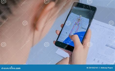 Woman Using Smartphone With Augmented Reality App 3d Model Of Human Body System Editorial Photo