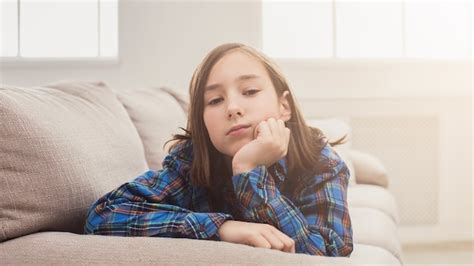 Premium Photo Tired Girl Sitting On Sofa At Home