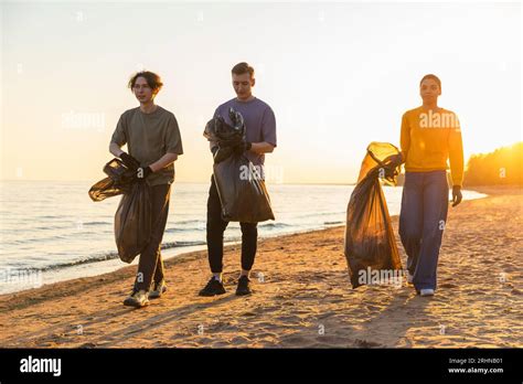 Earth Day Volunteers Activists Collects Garbage Cleaning Of Beach Coastal Zone Woman Mans With