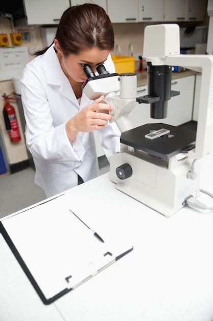 Premium Photo Portrait Of A Female Science Babe Looking In A Microscope