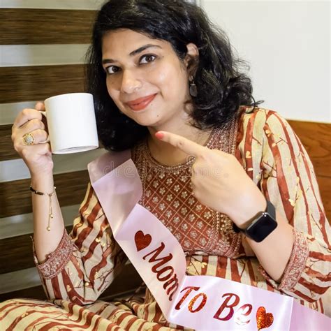A Pregnant Indian Lady Poses For Outdoor Pregnancy Shoot And Hands On