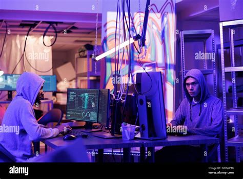 Hackers Collaborating While Coding Virus Software Doing Illegal