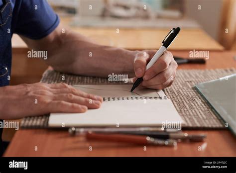 Glass Worker Drawing Wavy Line In Notepad When Working On Sketches For