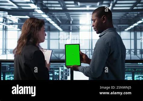 Server Room Data Scientists Using Mockup Tablet Conducting Security Audits To Prevent Bugs