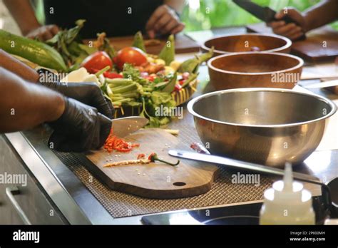 Adult Students Learning Recipe And Preparing Meal In Cooking Class Stock Photo Alamy